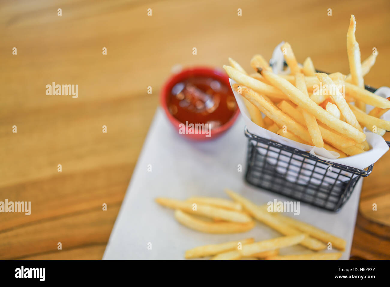 French fries on wood table Stock Photo - Alamy