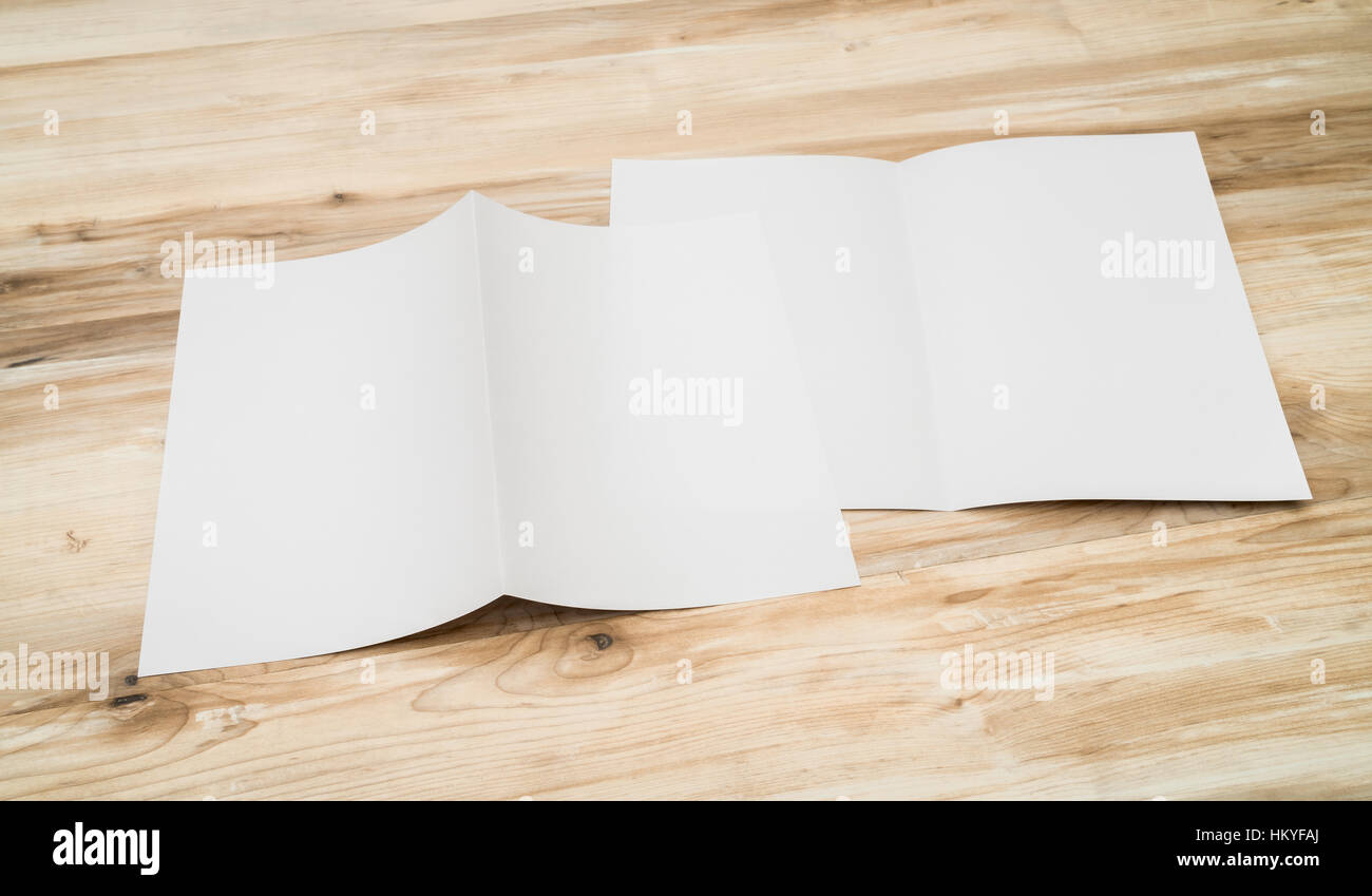 Bifold white template paper on wood texture Stock Photo - Alamy