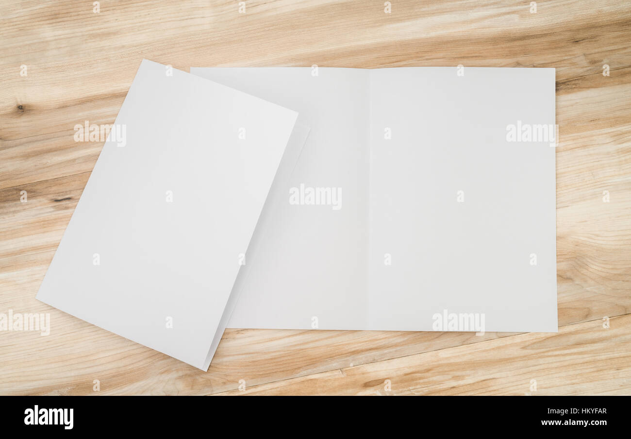 Bifold white template paper on wood texture Stock Photo - Alamy