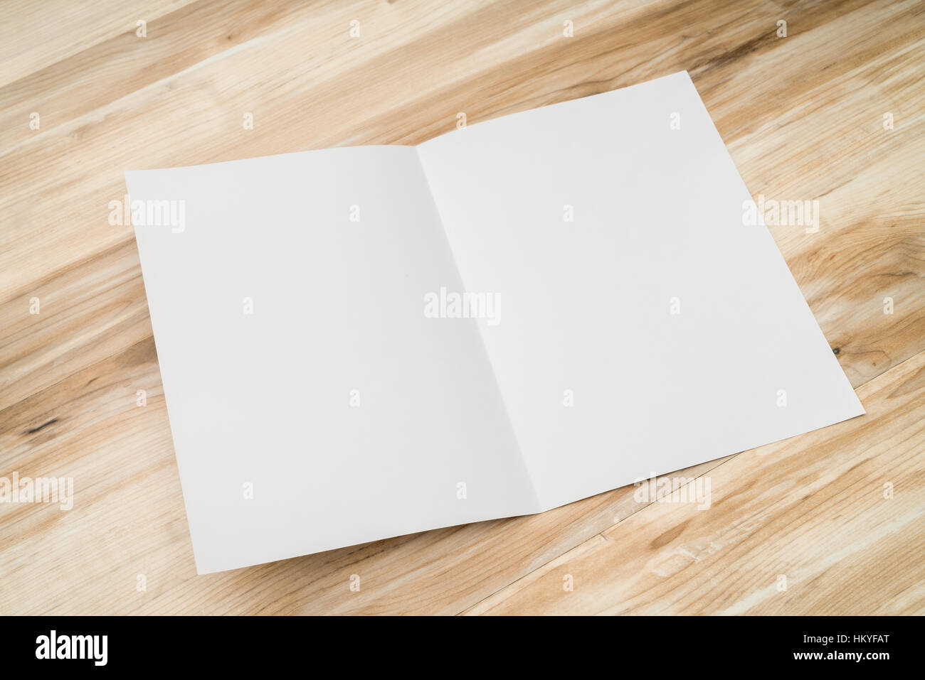 Bifold white template paper on wood texture Stock Photo - Alamy