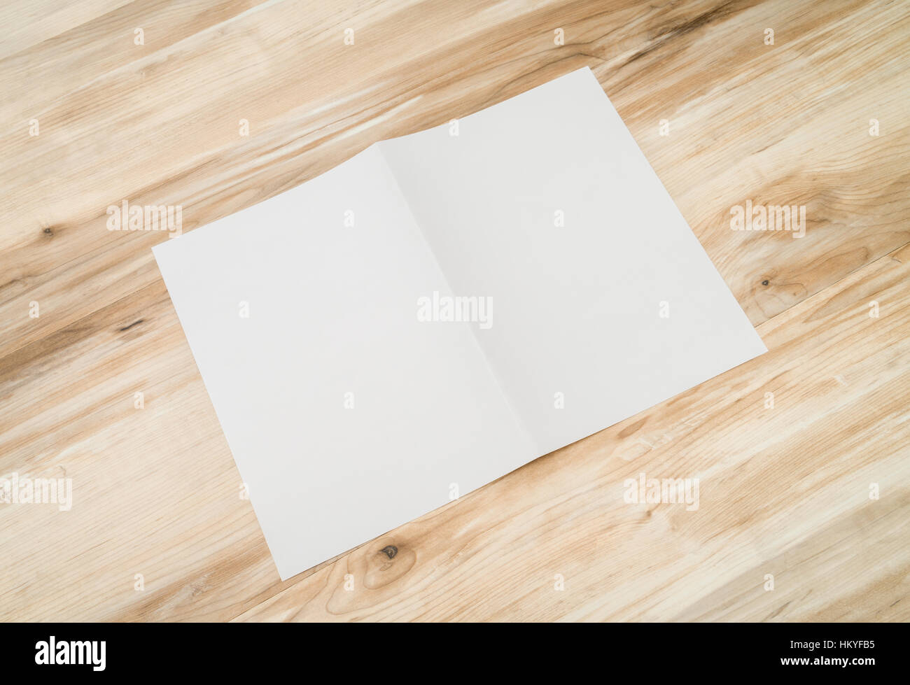 Bifold white template paper on wood texture Stock Photo - Alamy