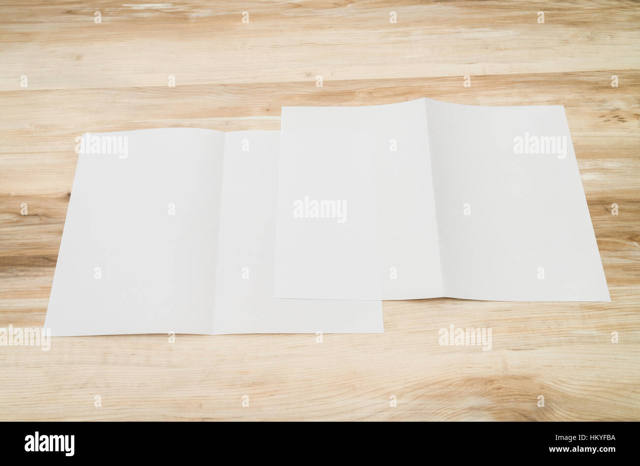 Bifold white template paper on wood texture Stock Photo - Alamy
