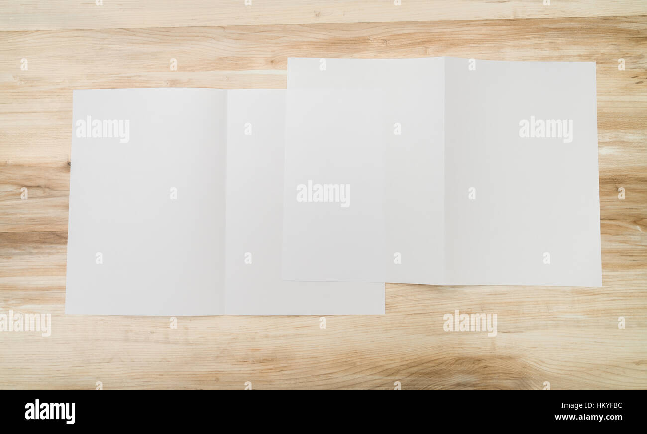 Bifold white template paper on wood texture Stock Photo - Alamy