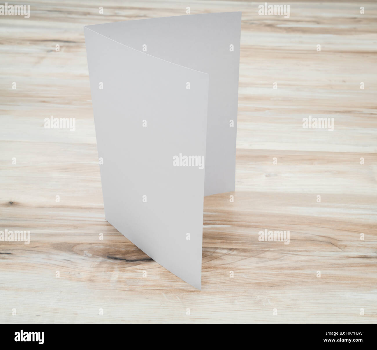 Bifold white template paper on wood texture Stock Photo - Alamy