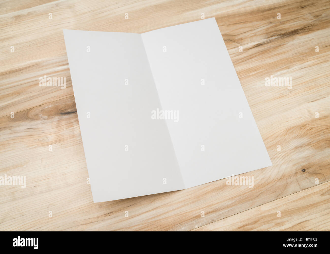Bifold white template paper on wood texture Stock Photo - Alamy