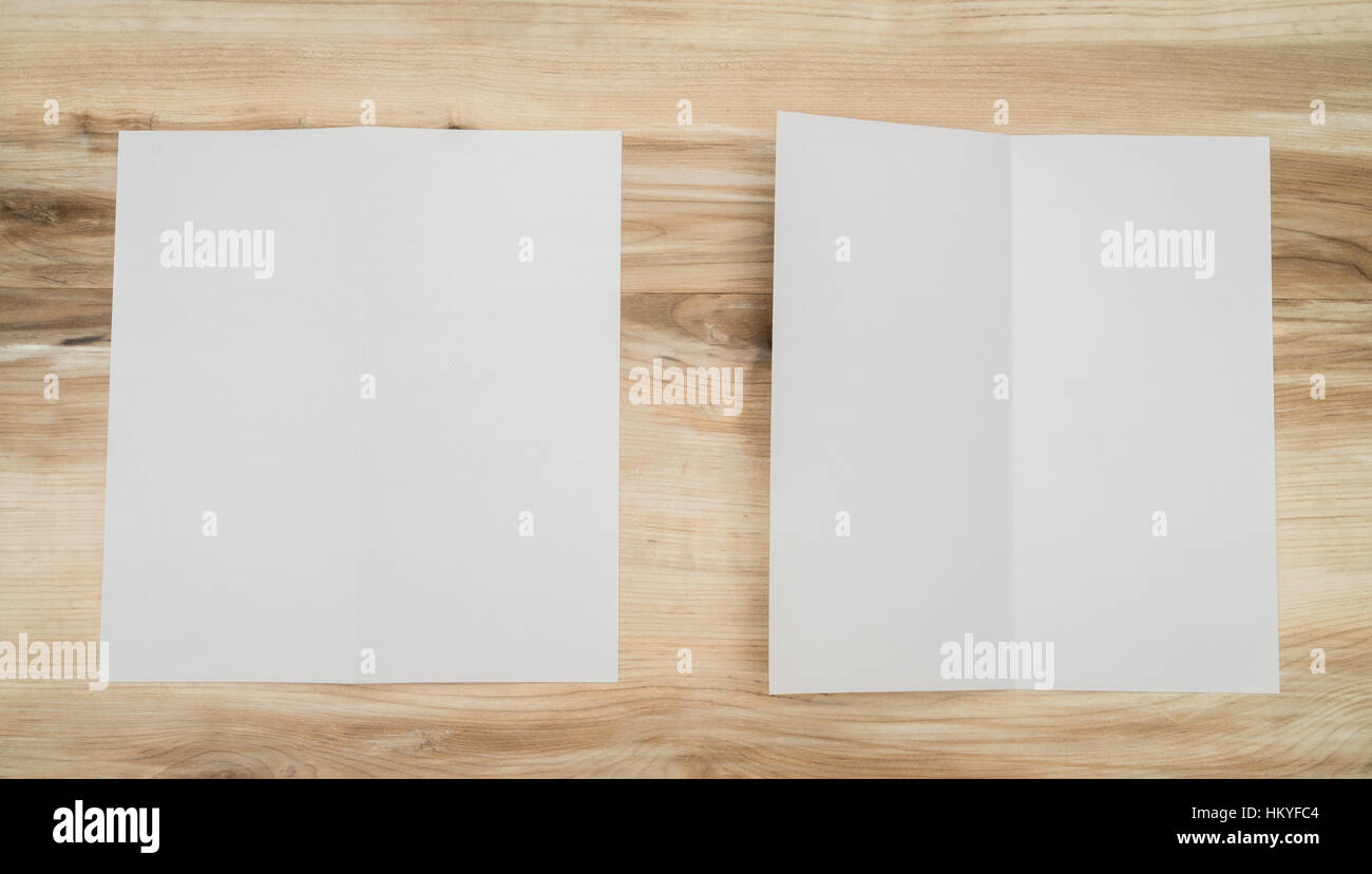 Bifold white template paper on wood texture Stock Photo - Alamy