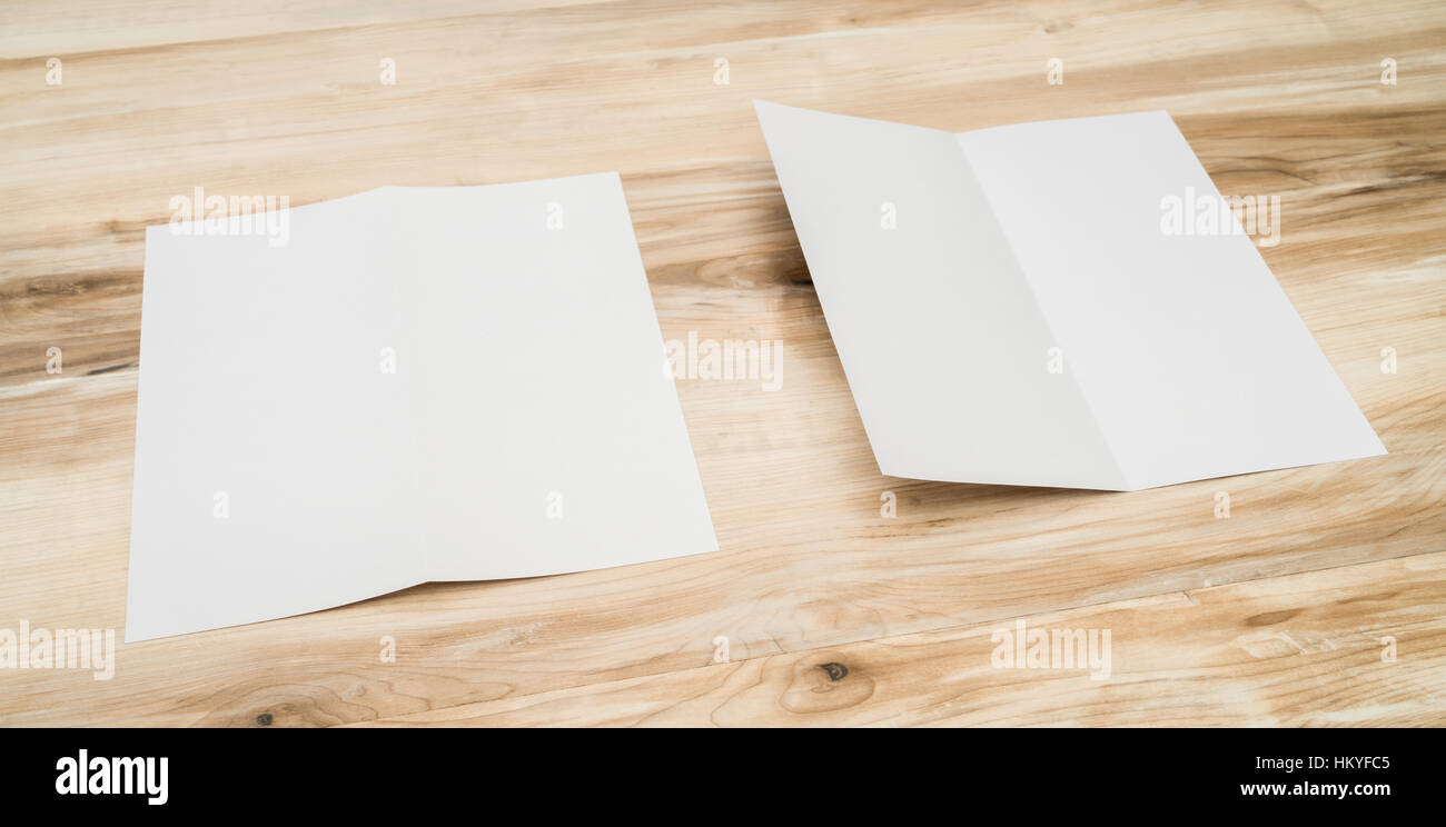 Bifold white template paper on wood texture Stock Photo - Alamy