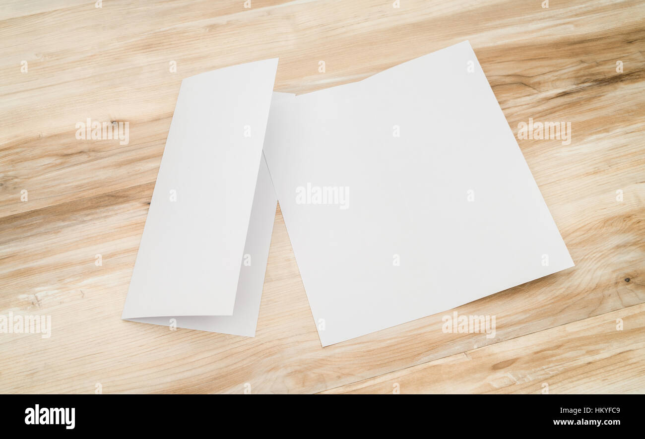 Bifold white template paper on wood texture Stock Photo - Alamy