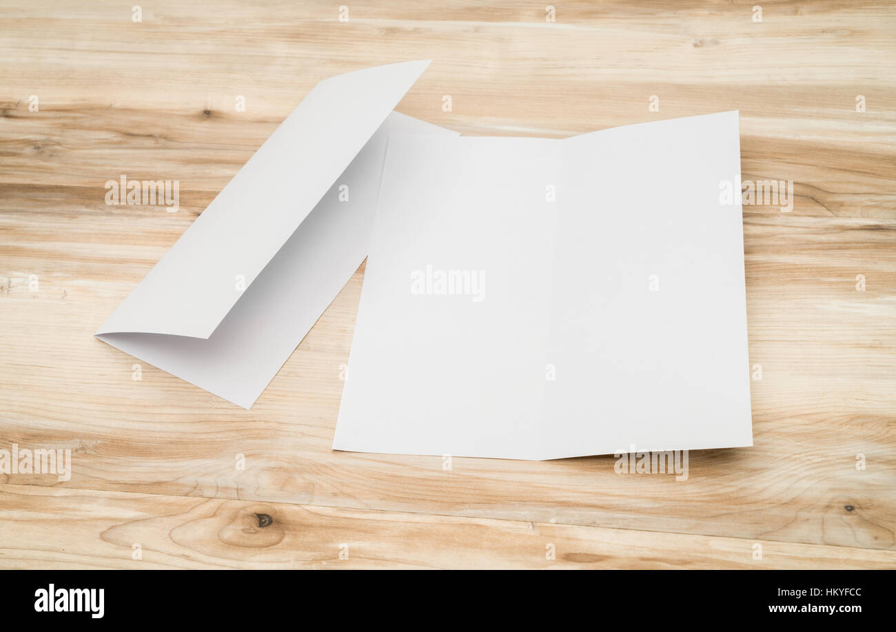 Bifold white template paper on wood texture Stock Photo - Alamy