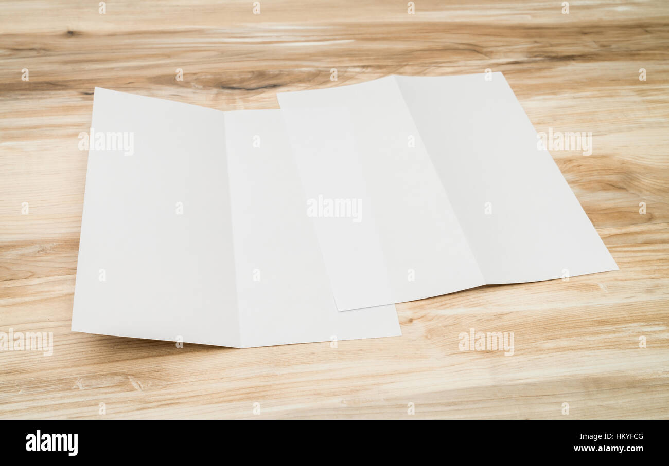 Bifold white template paper on wood texture Stock Photo - Alamy