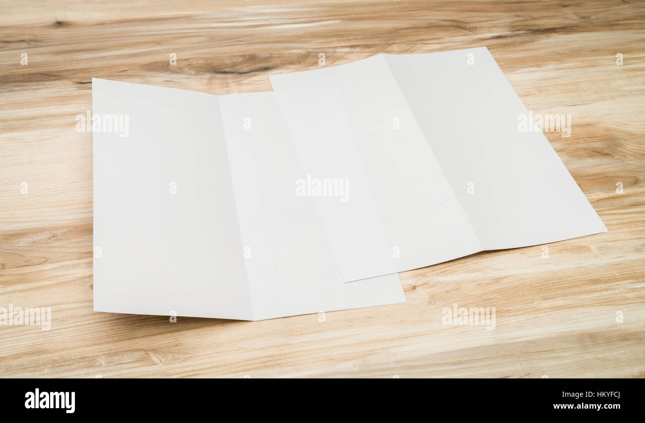 Bifold white template paper on wood texture Stock Photo - Alamy