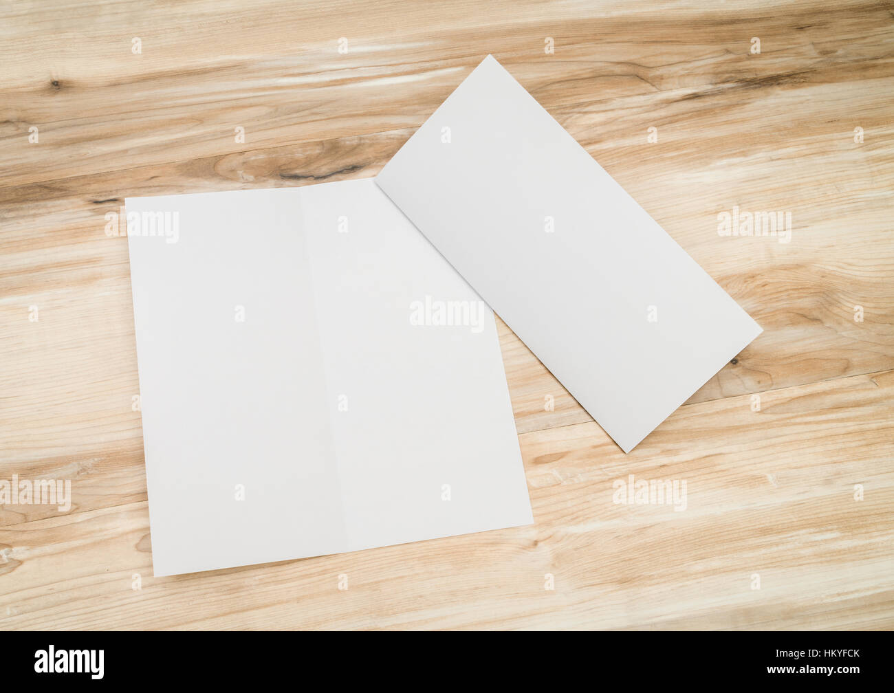 Bifold white template paper on wood texture Stock Photo - Alamy