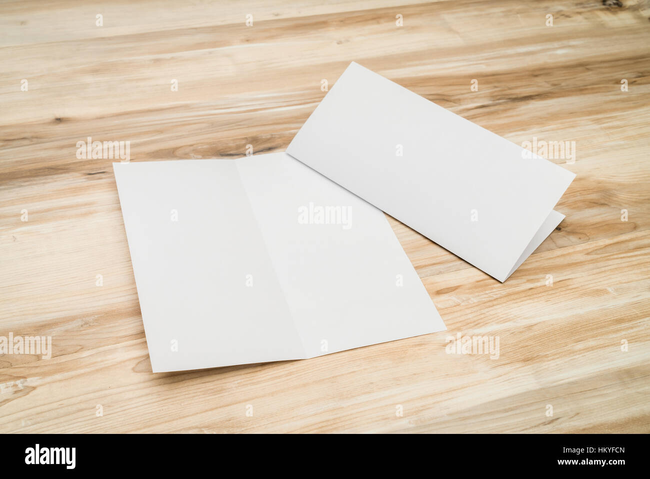 Bifold white template paper on wood texture Stock Photo - Alamy