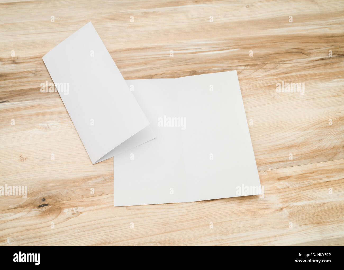 Bifold white template paper on wood texture Stock Photo - Alamy