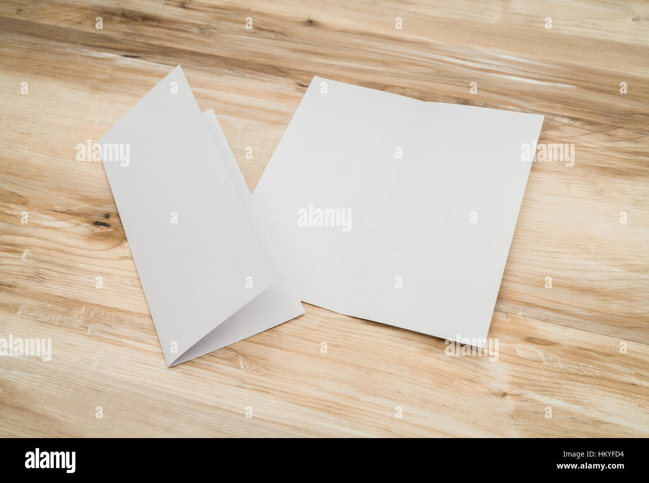 Bifold white template paper on wood texture Stock Photo - Alamy