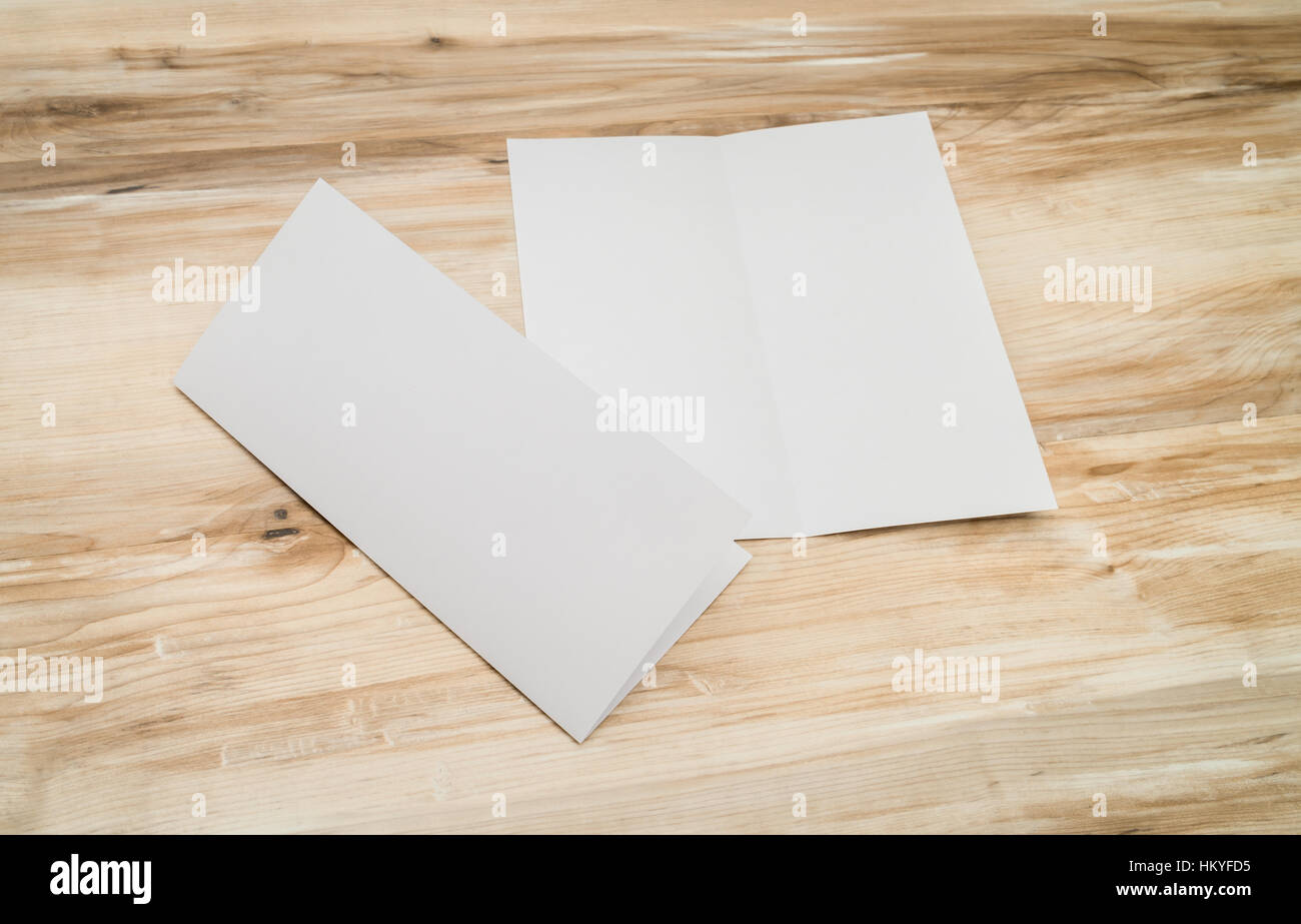 Bifold white template paper on wood texture Stock Photo - Alamy