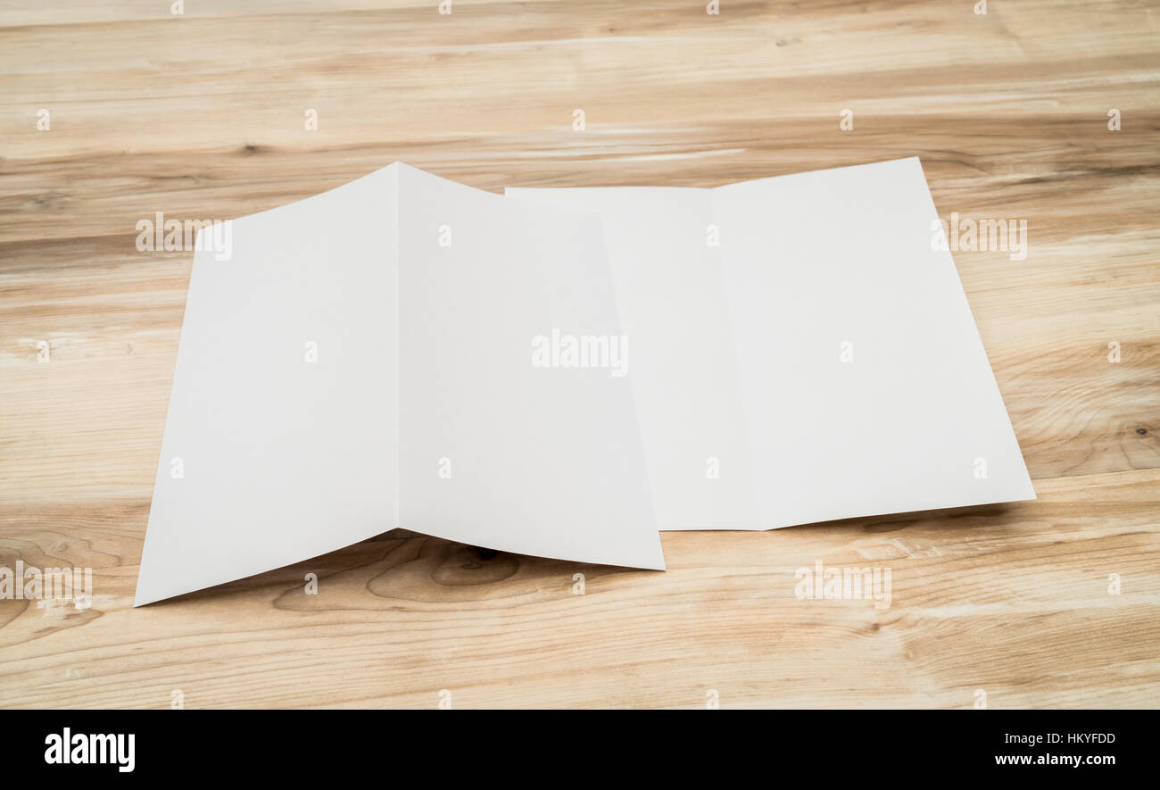 Bifold white template paper on wood texture Stock Photo - Alamy