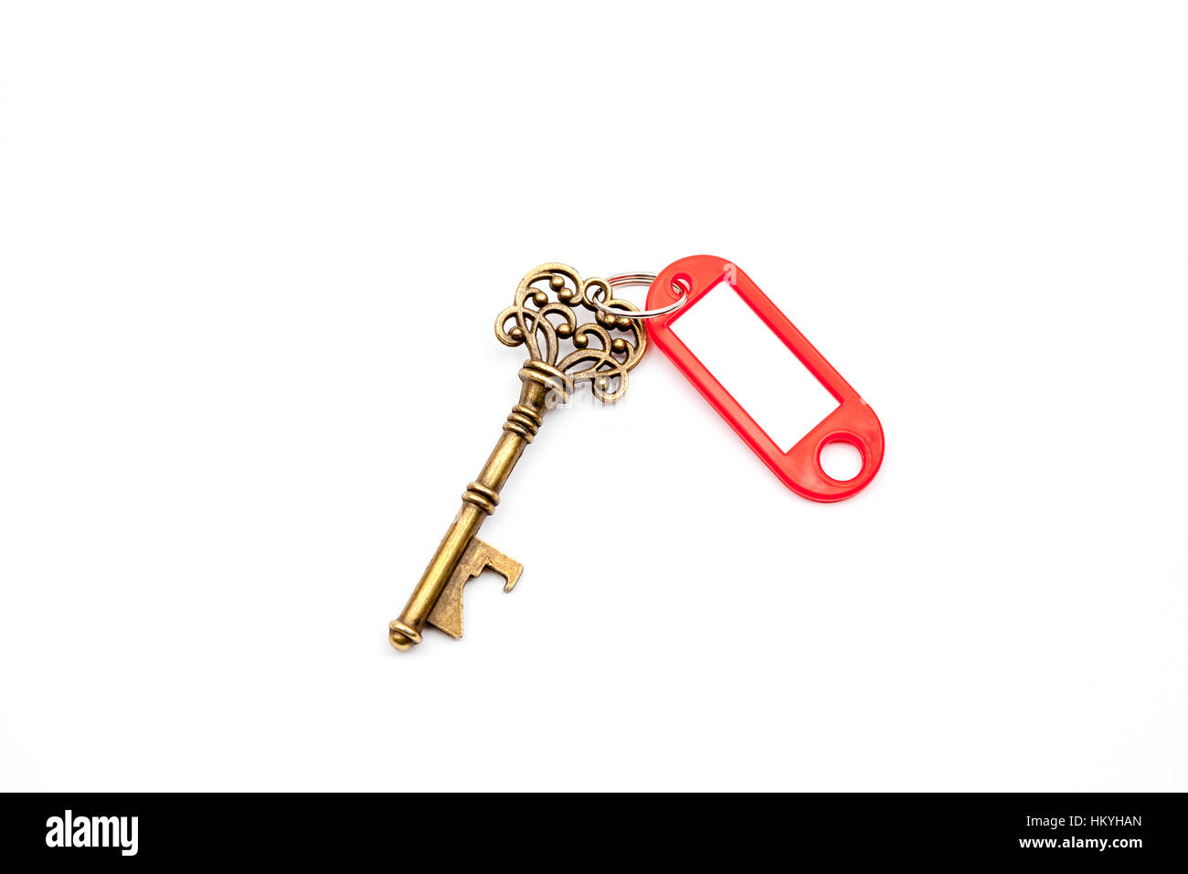 on white background an antique key with color label Stock Photo - Alamy
