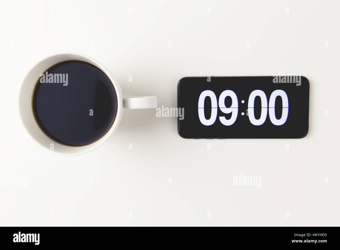 Morning coffee with time display on digital phone clock Stock Photo - Alamy