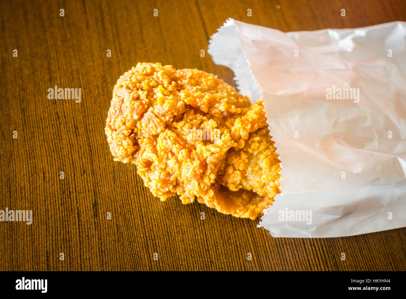 Fried Chicken Wings in paper bag on wood table Stock Photo - Alamy
