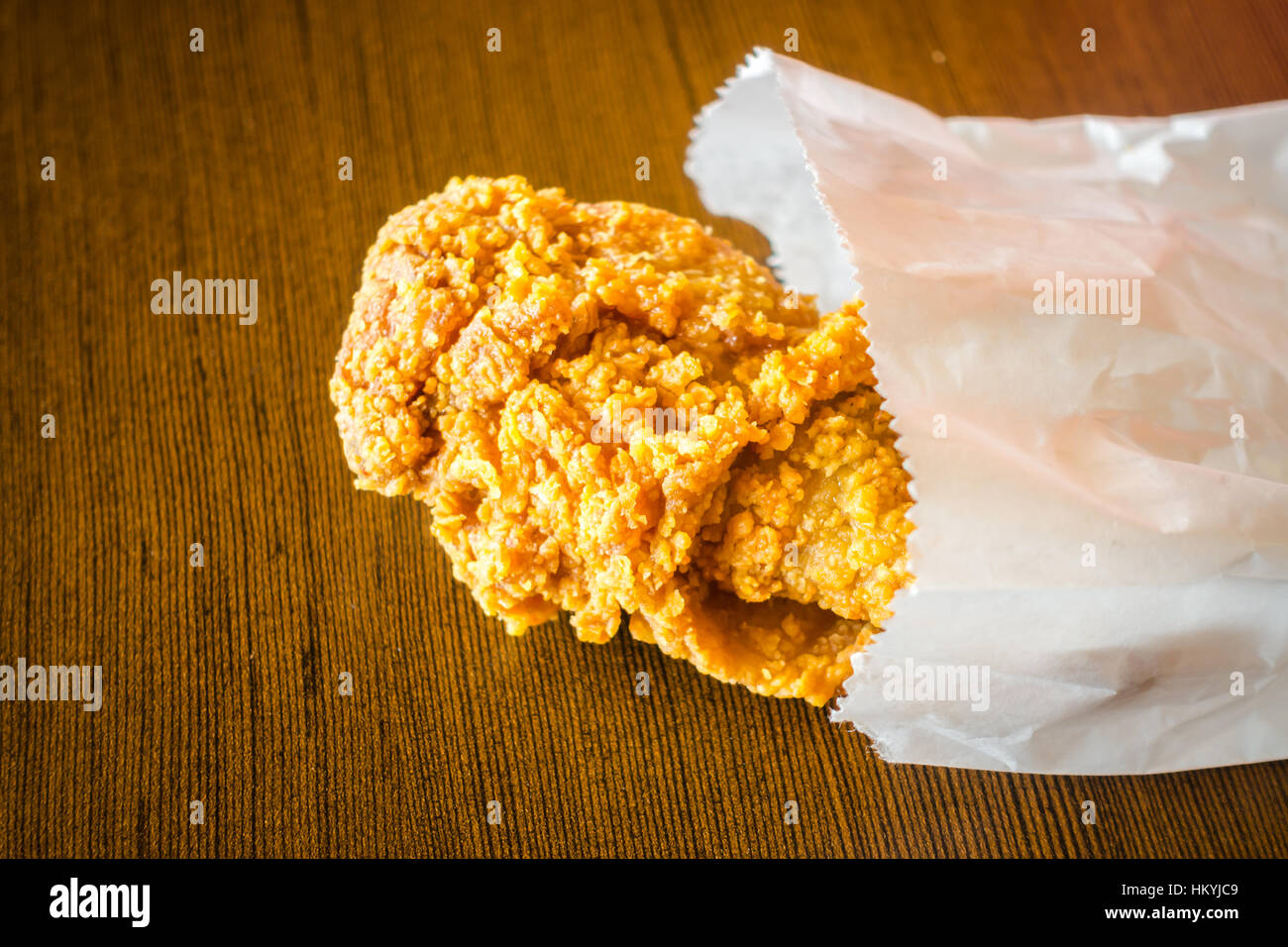 Fried Chicken Wings in paper bag on wood table Stock Photo - Alamy