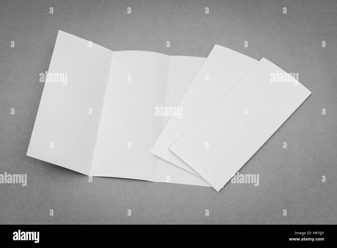 Trifold white template paper on gray background Stock Photo - Alamy
