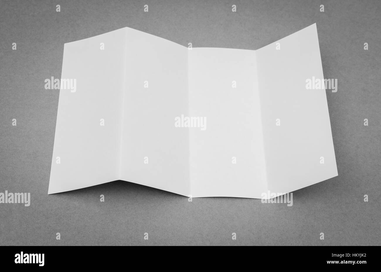 Four - fold white template paper on gray background Stock Photo - Alamy