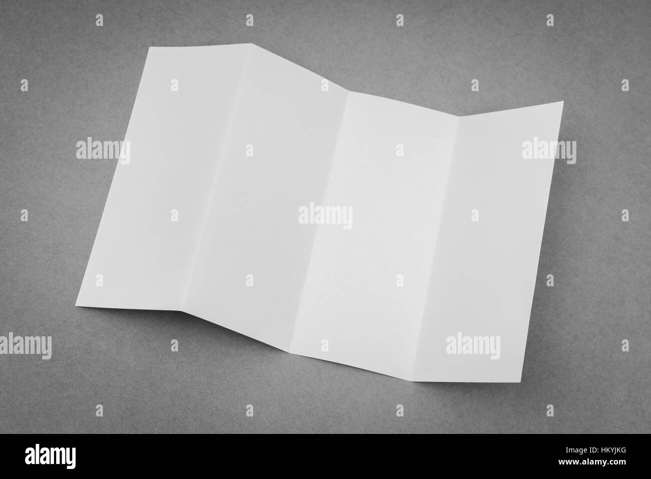 Four - fold white template paper on gray background Stock Photo - Alamy