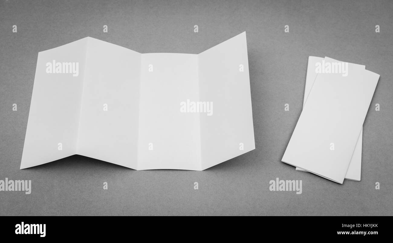 Four - fold white template paper on gray background Stock Photo - Alamy