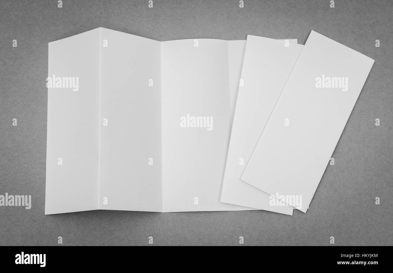 Four - fold white template paper on gray background Stock Photo - Alamy