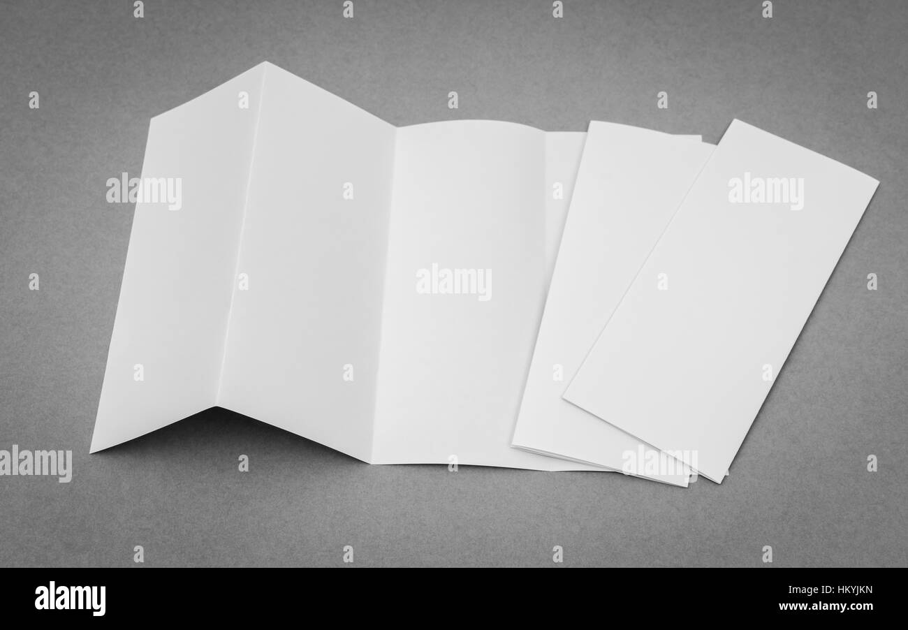 Four - fold white template paper on gray background Stock Photo - Alamy
