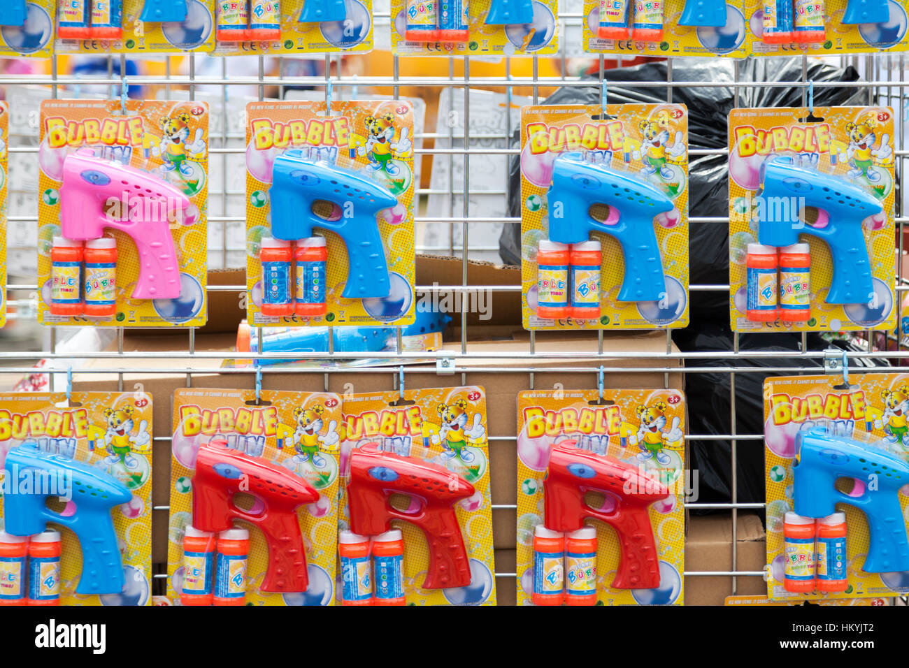 Red and Blue toy bubble guns hung on a wire display rack Stock Photo ...