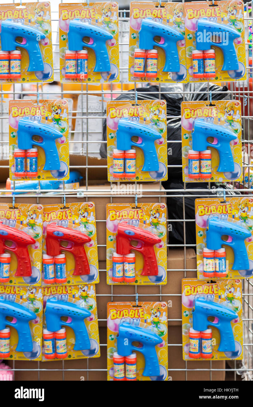 Red and Blue toy bubble guns hung on a wire display rack Stock Photo ...