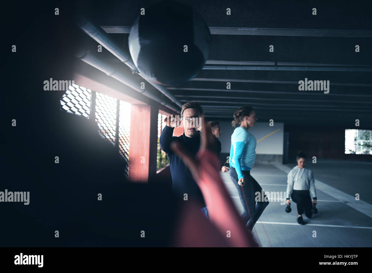 View of two men throwing ball to each other while working out indoors ...