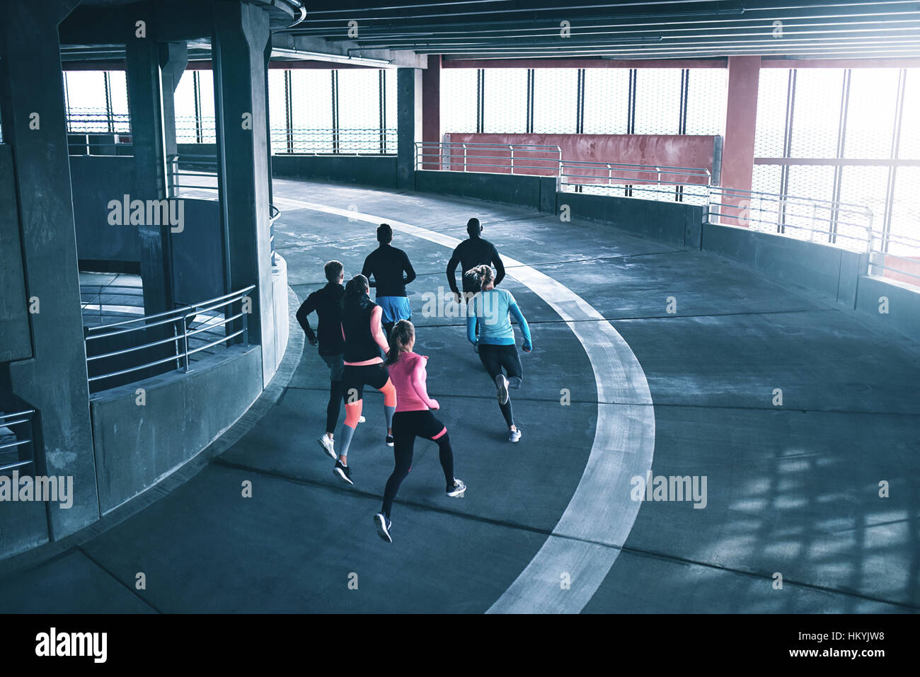 Back view of athletes in sportswear training on race track in gym Stock ...