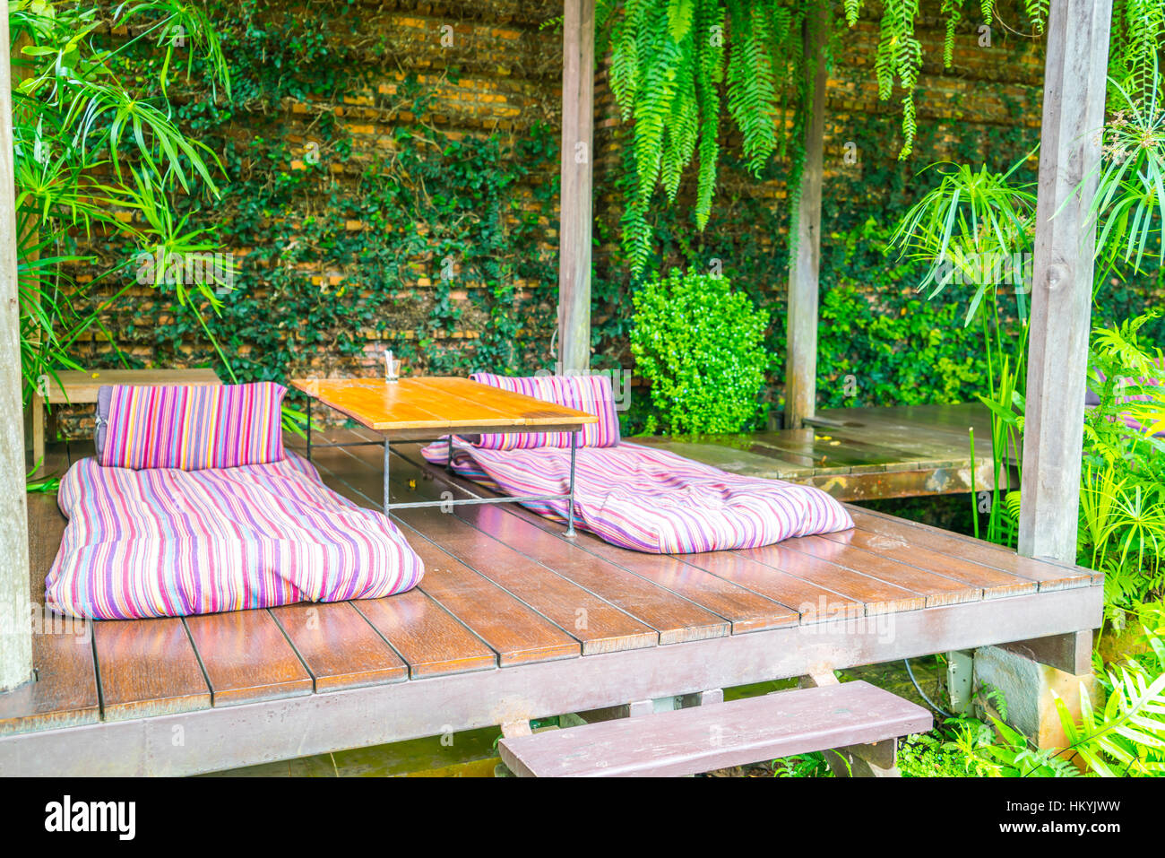 Relaxation space in garden with beds Stock Photo - Alamy