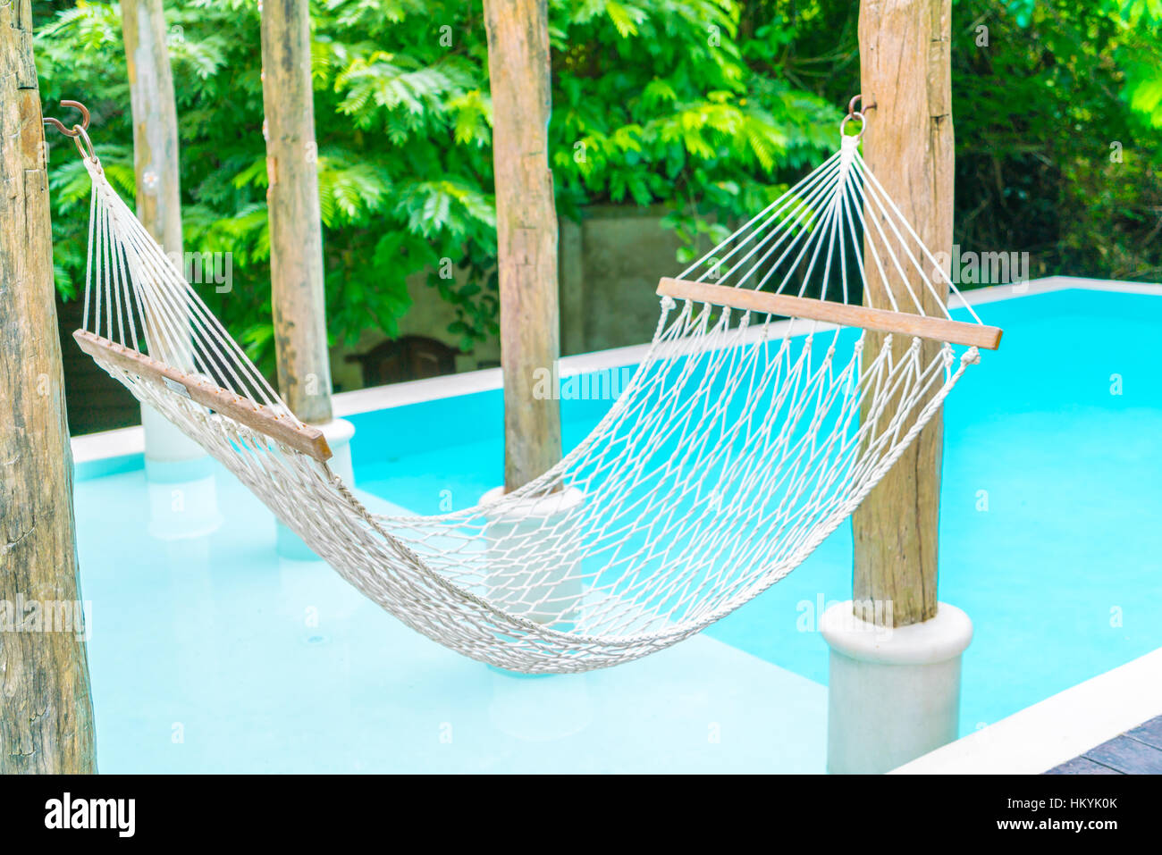 White hammocks in Luxury swimming pool Stock Photo - Alamy