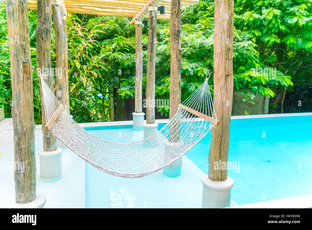 White hammocks in Luxury swimming pool Stock Photo - Alamy