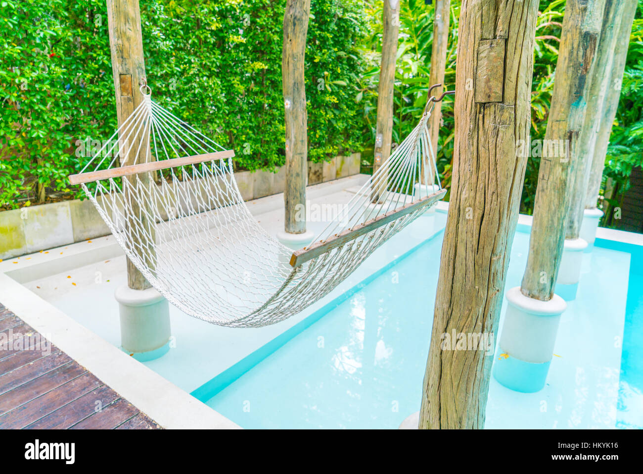 White hammocks in Luxury swimming pool Stock Photo - Alamy