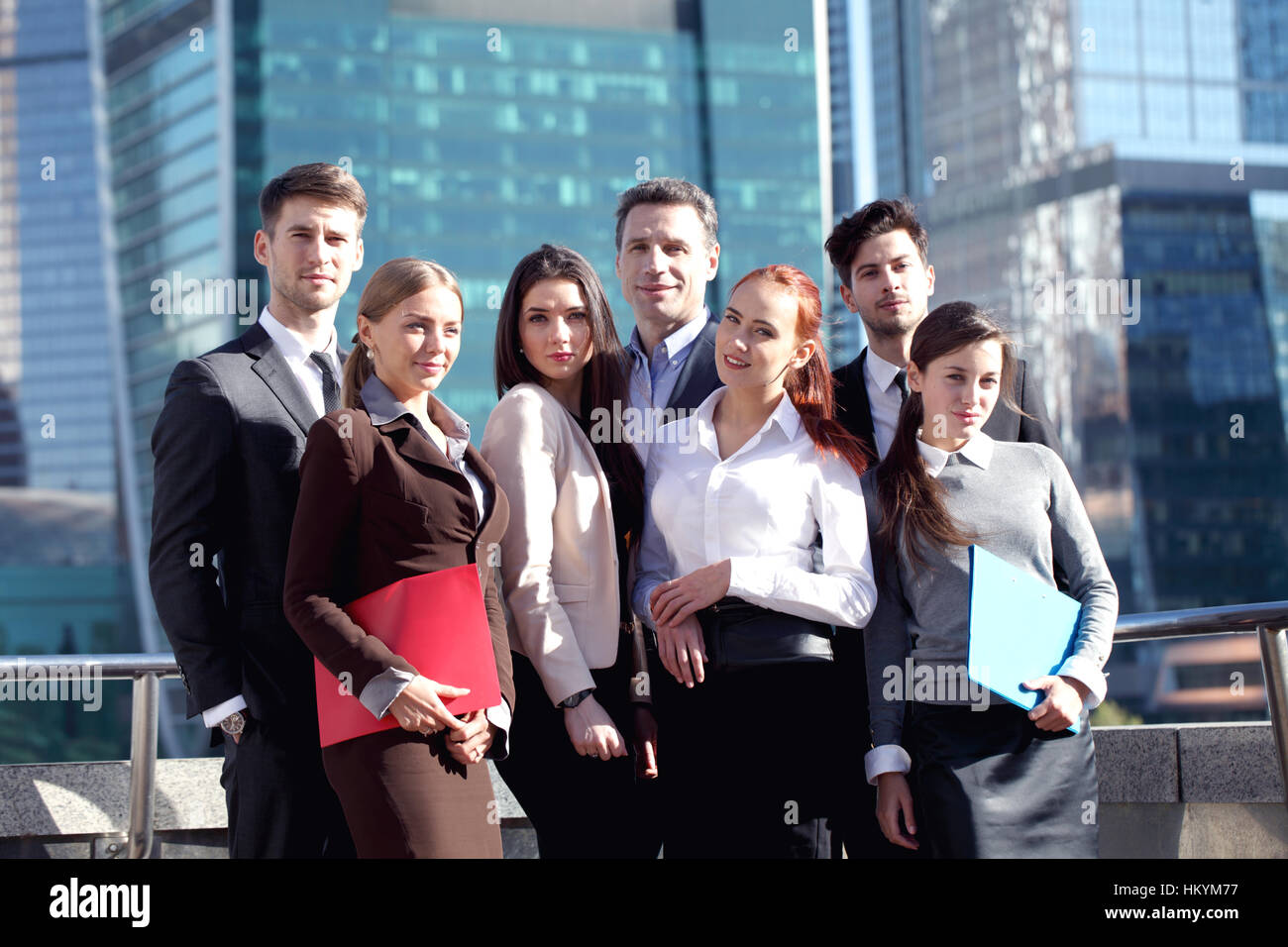 Portrait of business team outside office on skyscrapers background ...
