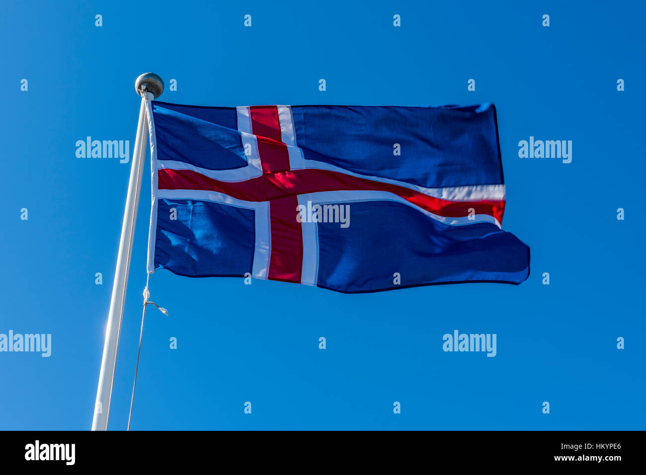 Icelandic flag waving in the wind with blue sky Stock Photo - Alamy