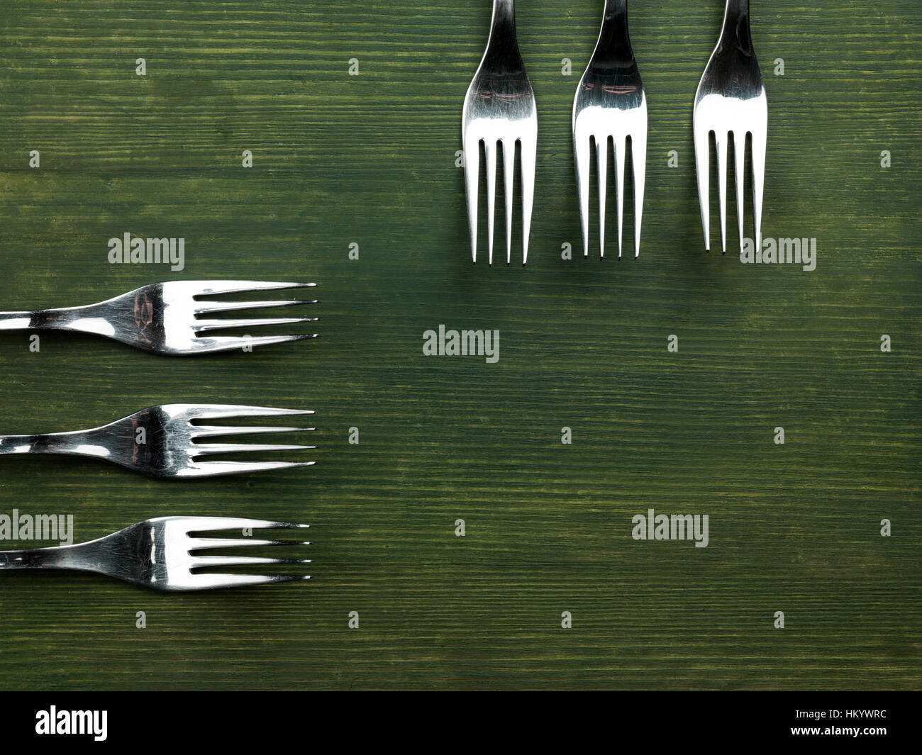 Used Household Kitchen Forks On A Green Board Background Stock Photo ...