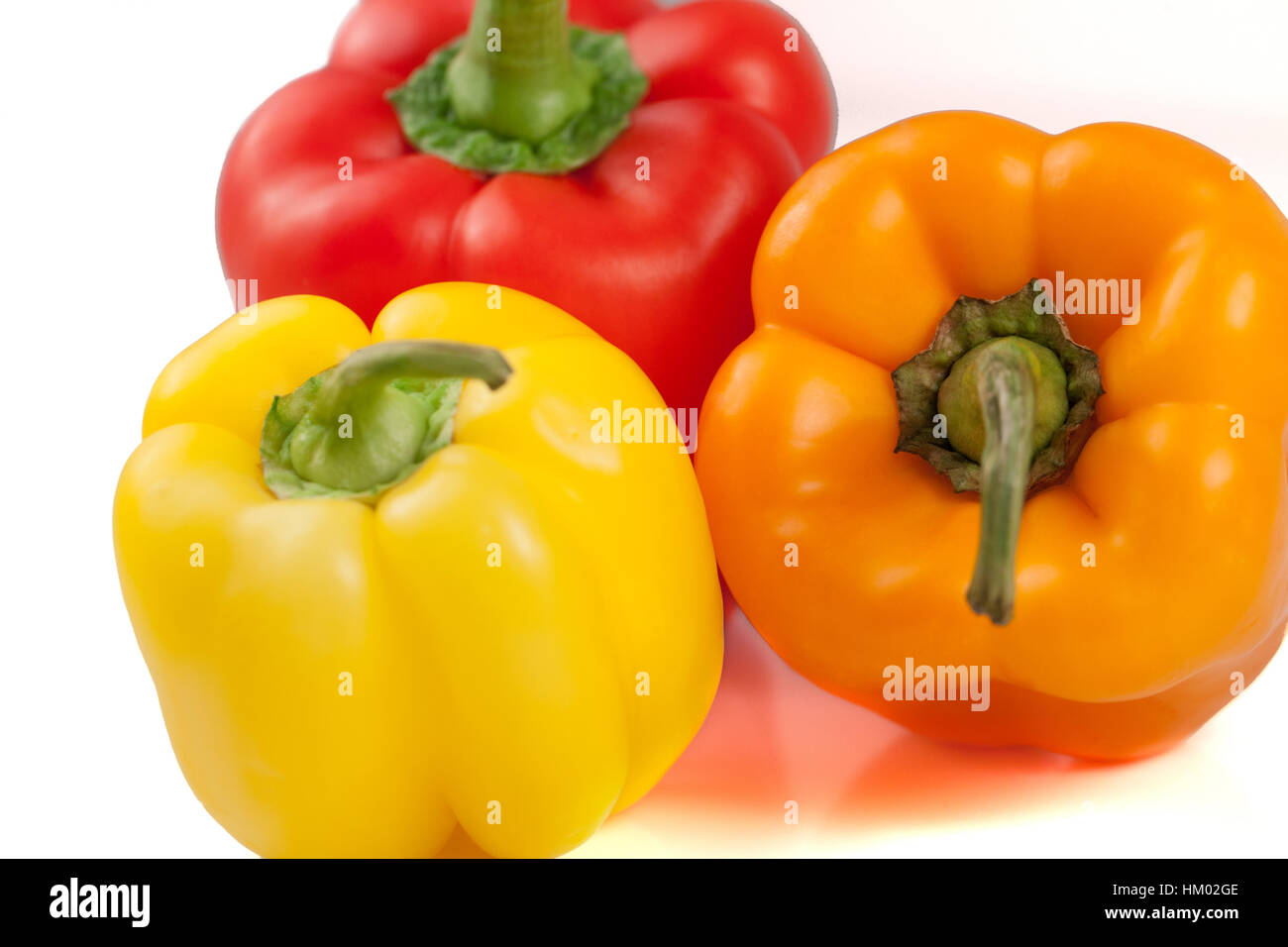 Three juicy bellpeppers isolated on white background.Top view Stock ...