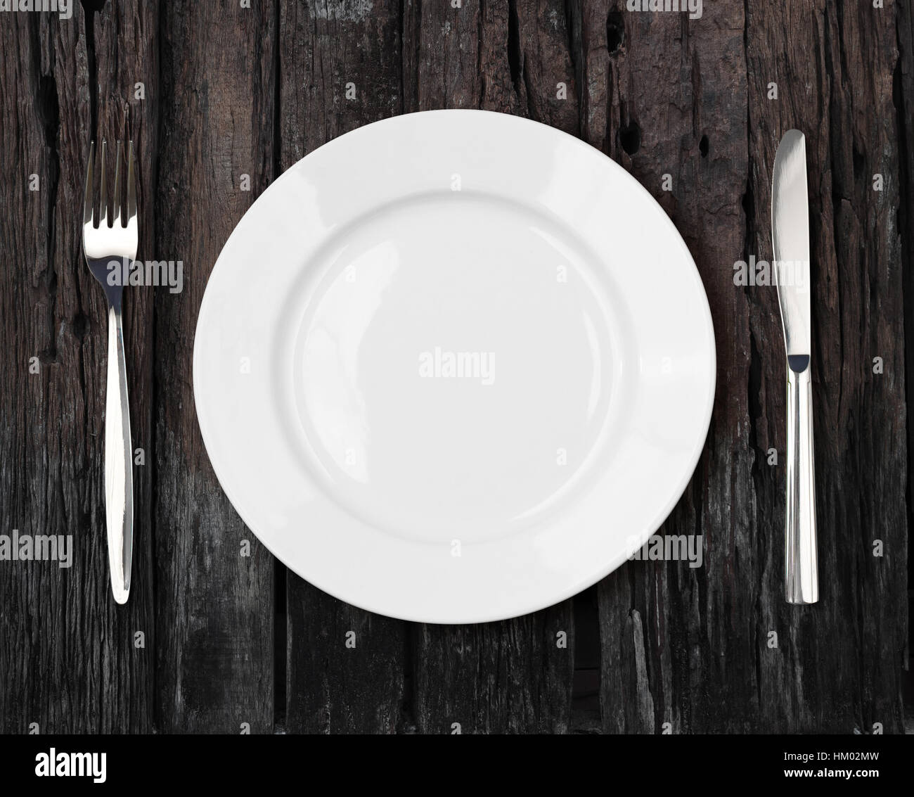 white empty dinner plate setting on old dark wooden table Stock Photo ...