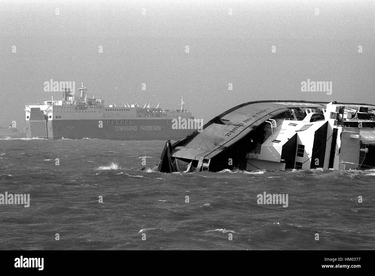 A Townsend Thoresen car ferry sails past the fleet's capsized Herald of ...