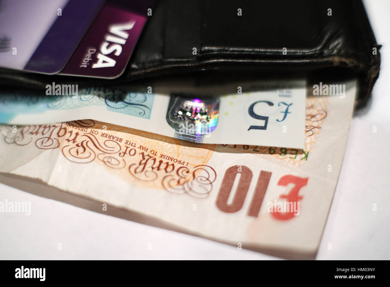 A five pound and ten pound banknote, along with Natwest bank cards in a ...