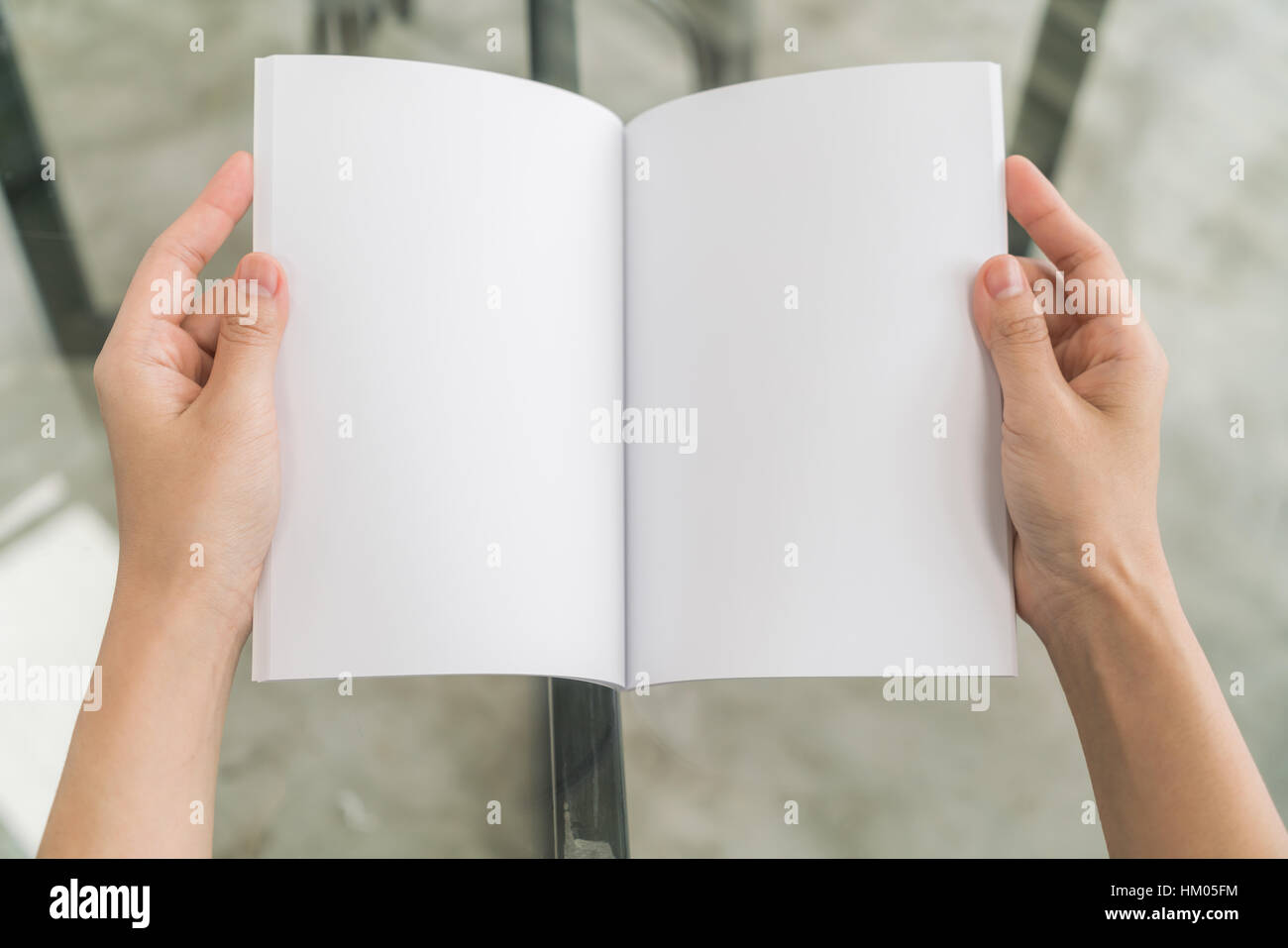 Hands open book on table Stock Photo - Alamy