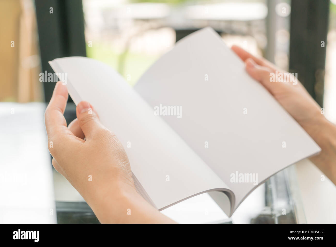Hands open book on table Stock Photo - Alamy
