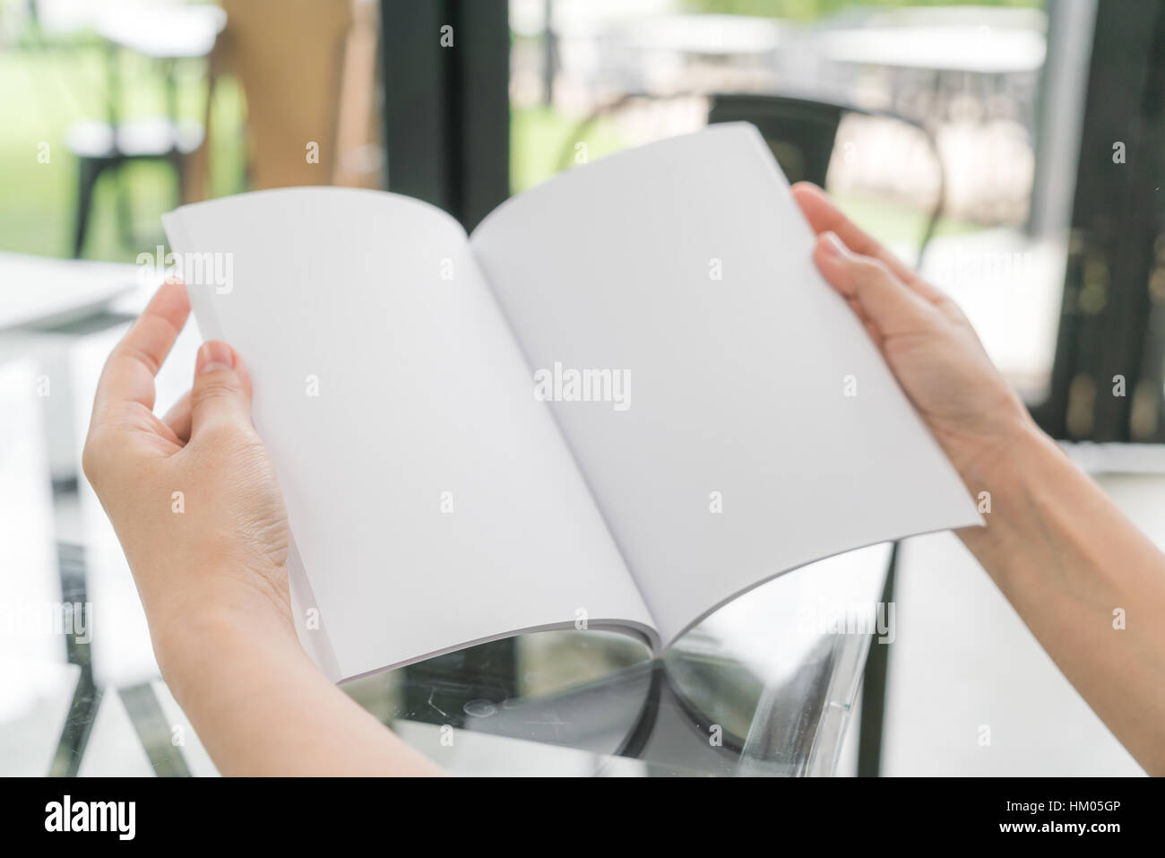 Hands open book on table Stock Photo - Alamy