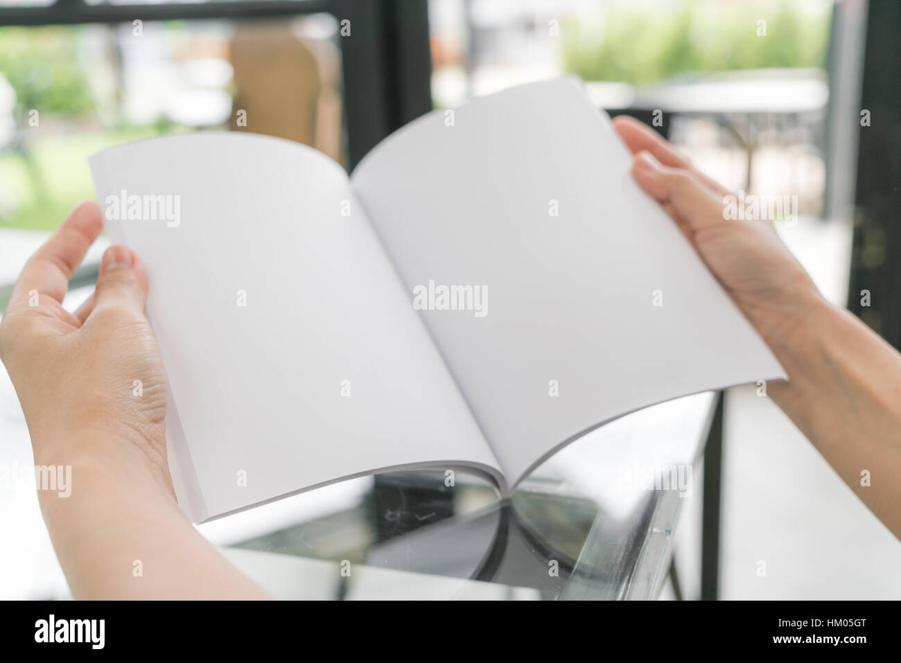 Hands open book on table Stock Photo - Alamy